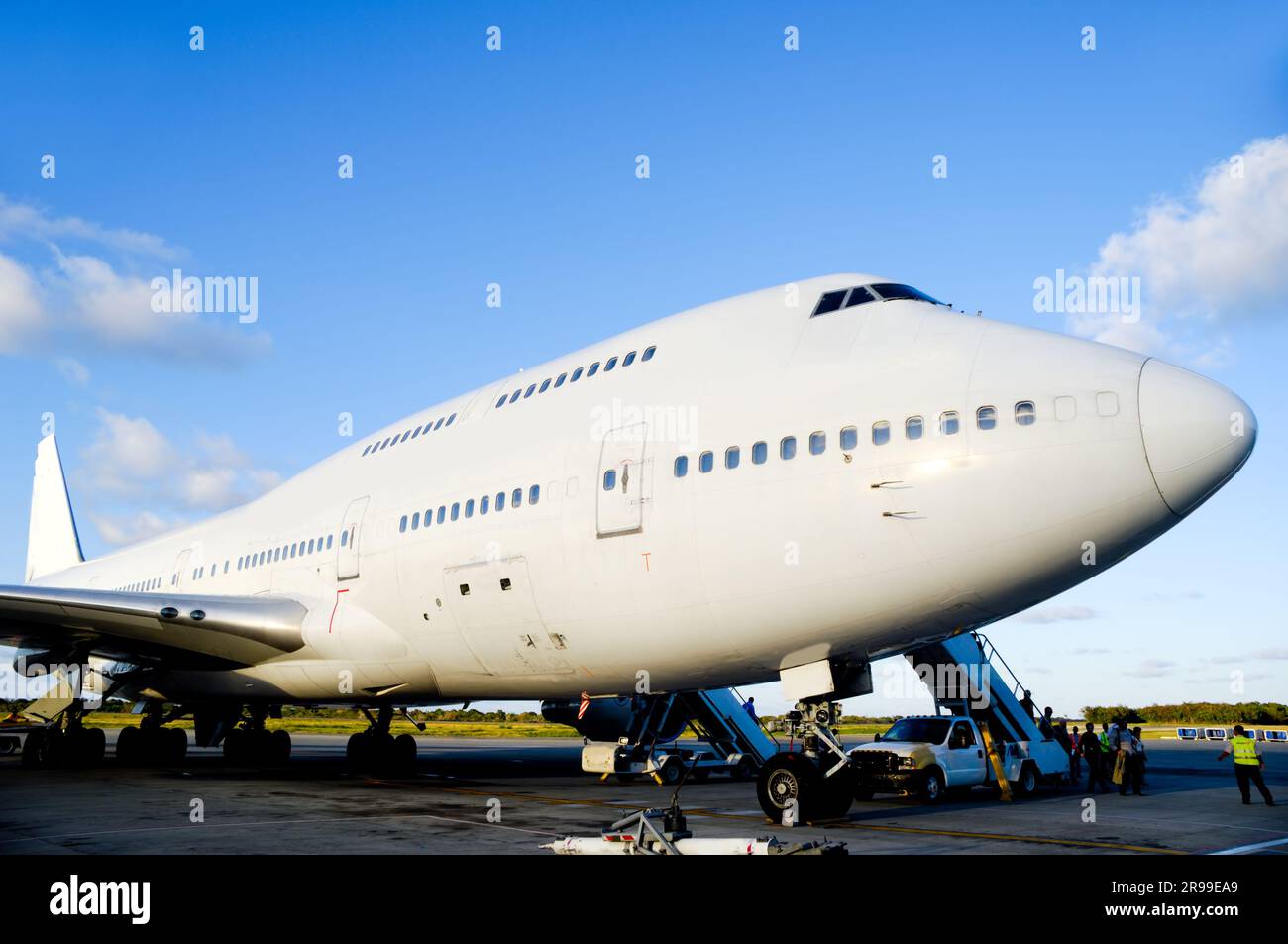 Air travel - A parked plane is loading off Passengers in an airport ...
