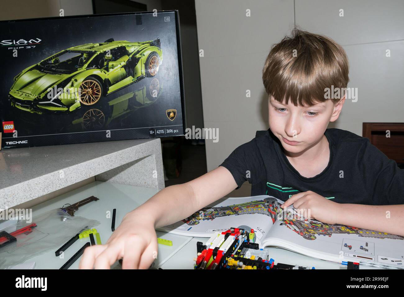 9 year old boy playing with Lego set Stock Photo - Alamy