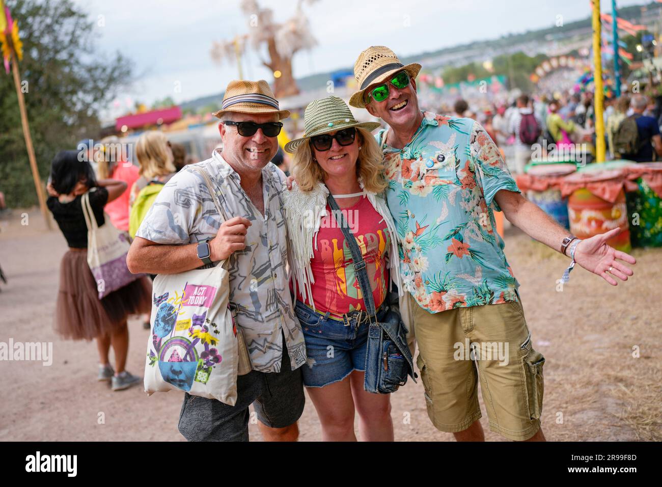 Festival goers pose for a photographer during the Glastonbury Festival ...