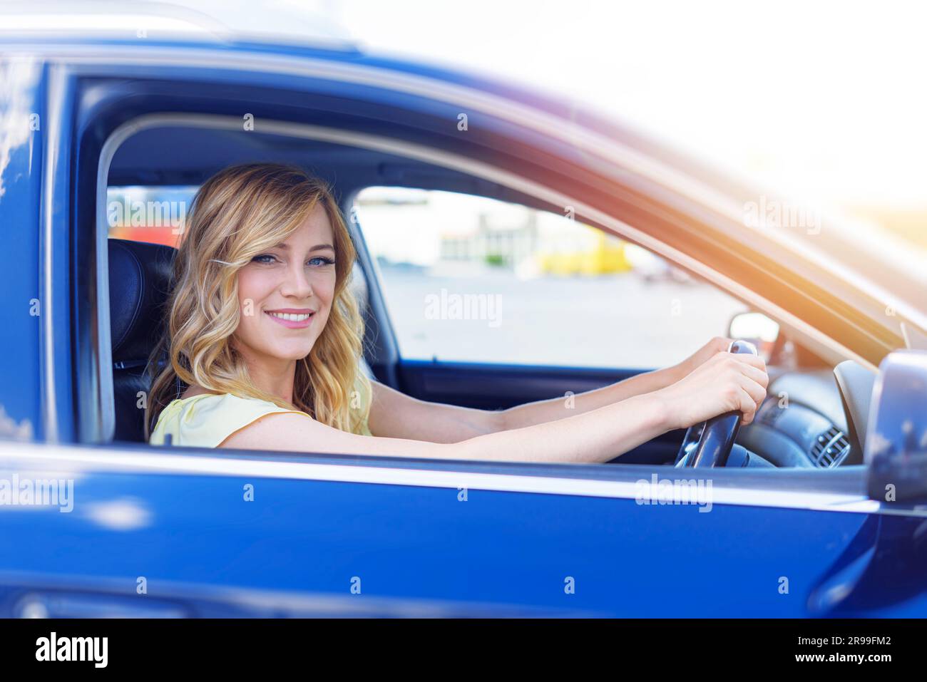 Beautiful blonde woman driving a car Stock Photo - Alamy