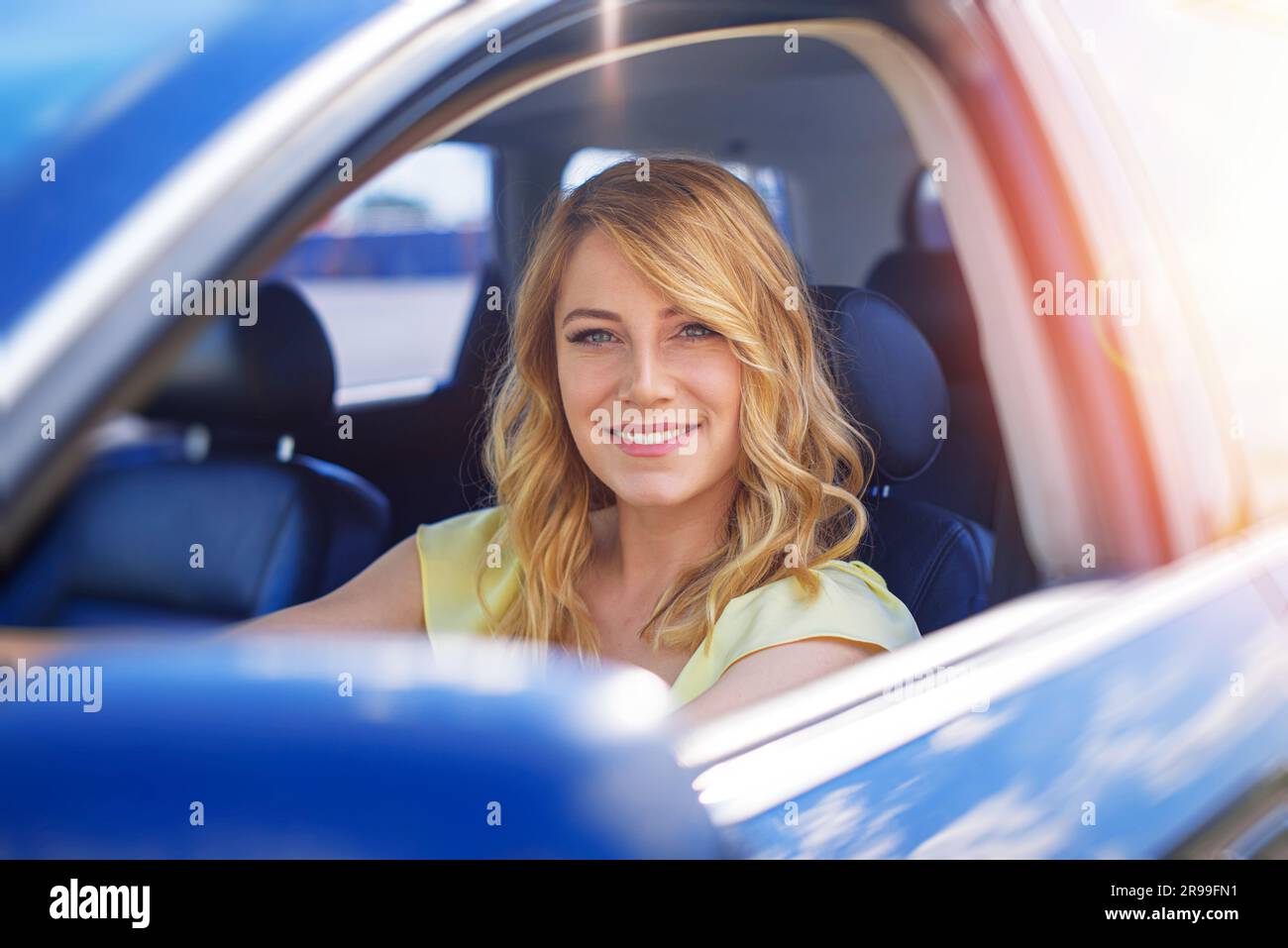 Beautiful blonde woman driving a car Stock Photo - Alamy