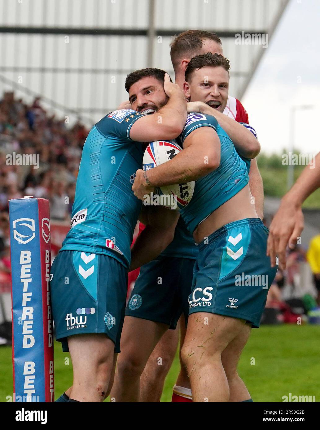 Wigan Warriors' (right) Abbas Miski celebrates scoring their side's ...