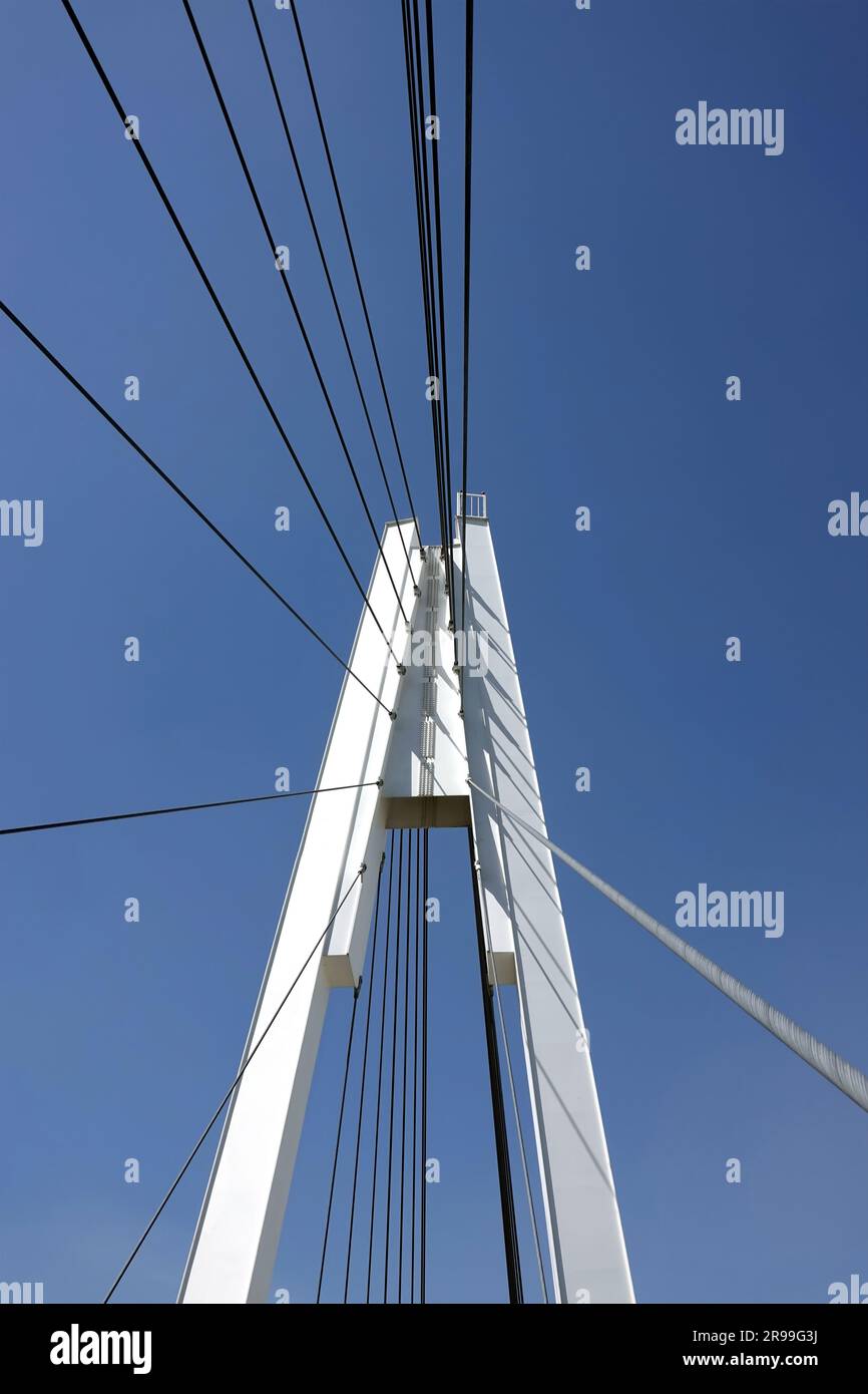 Modern urban cable-stayed bridge with metal ropes in the city district ...