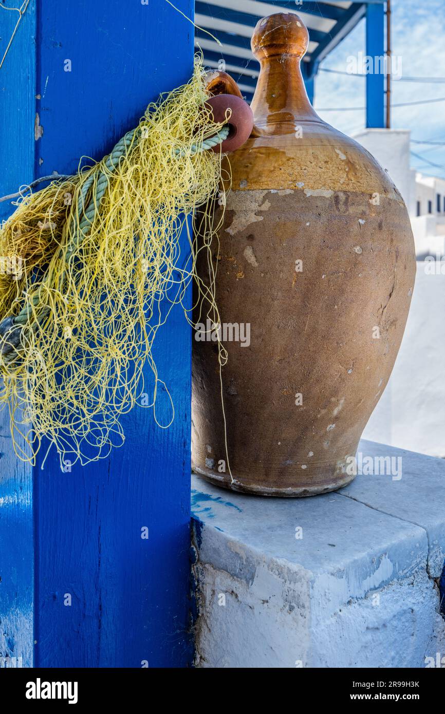Greek terracotta vase next to a decorative yellow fishing net. Naxos ...