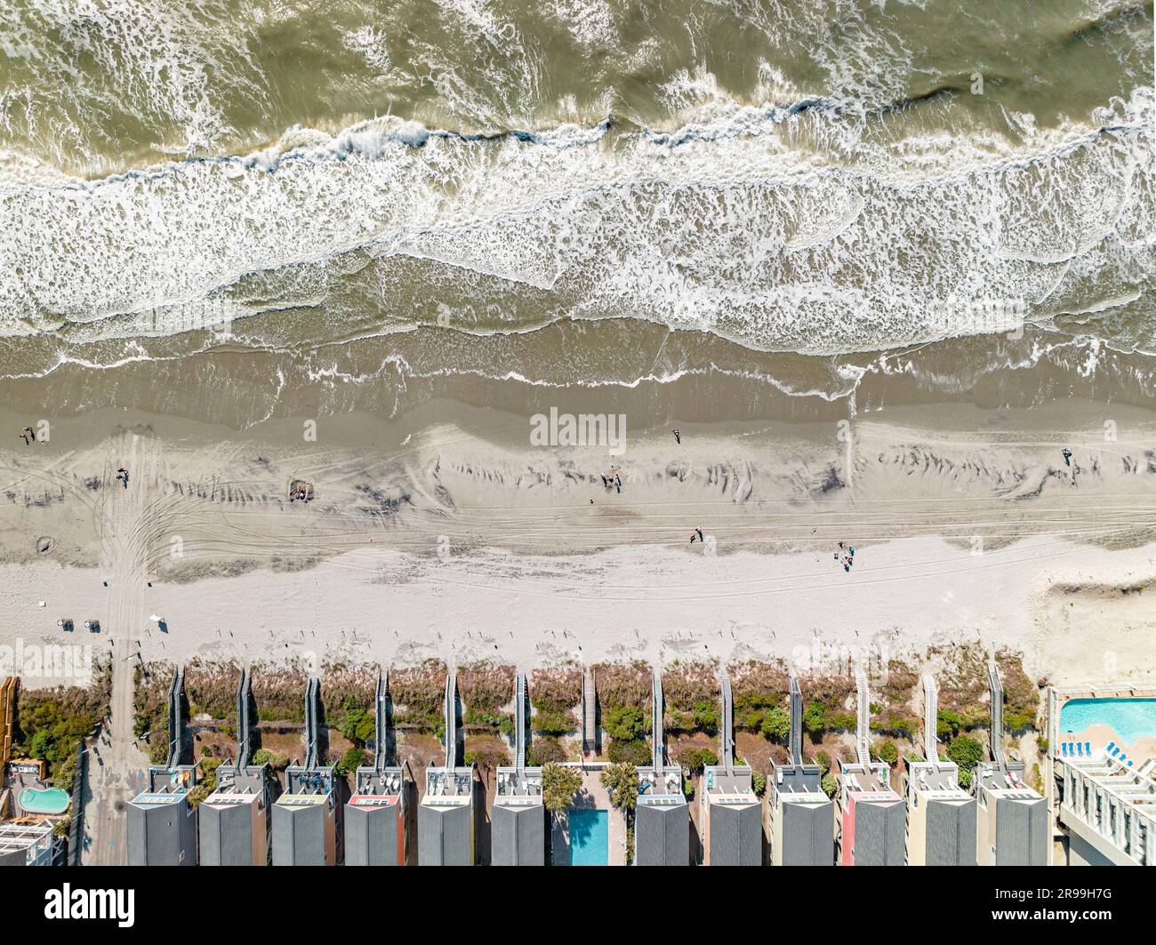 An aerial view of stunning view of beachfront condos situated along an ...