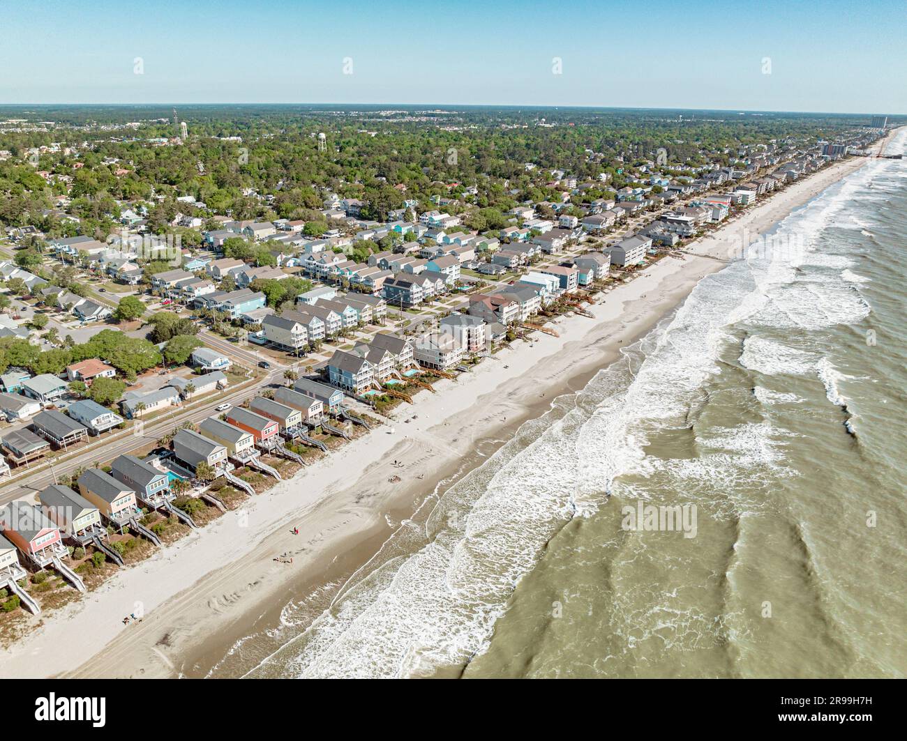 An aerial view of stunning view of beachfront condos situated along an ...