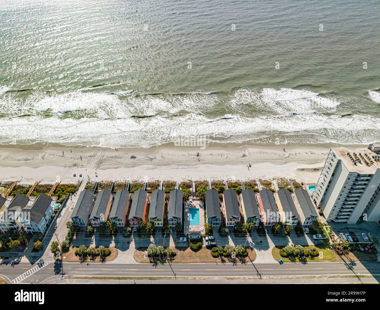 An aerial view of stunning view of beachfront condos situated along an ...
