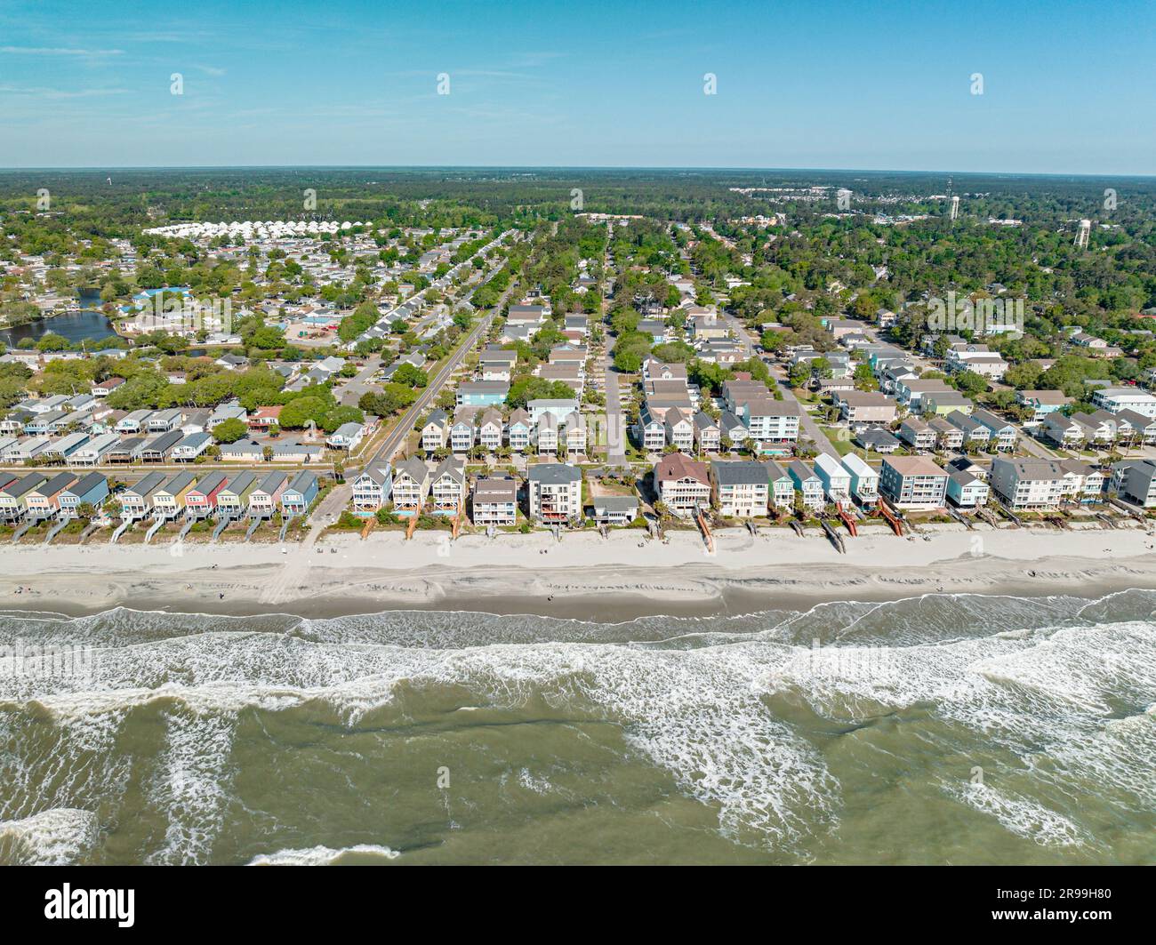 An aerial view of stunning view of beachfront condos situated along an ...