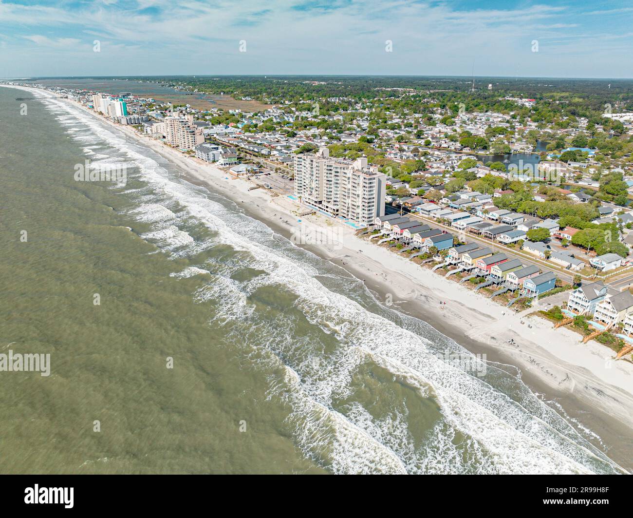 An aerial view of stunning view of beachfront condos situated along an ...