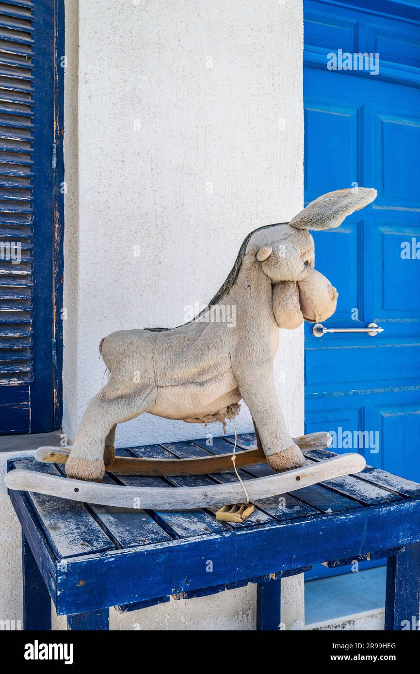 Abandoned stuffed donkey toy outside a traditional village house in ...