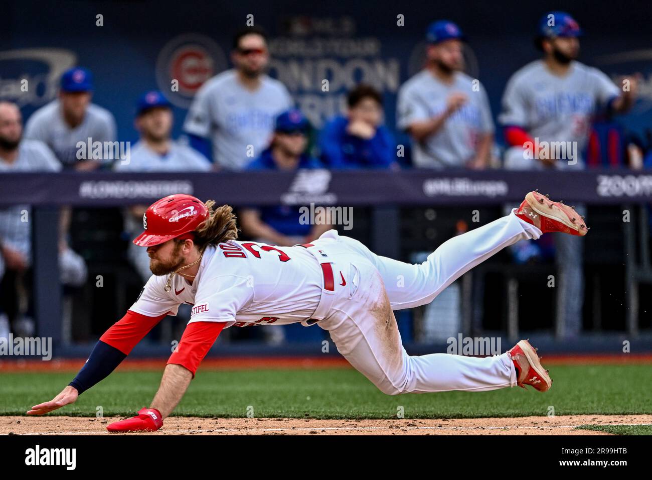 Brendan Donovan #33 of the St. Louis Cardinals dives onto home plate ...