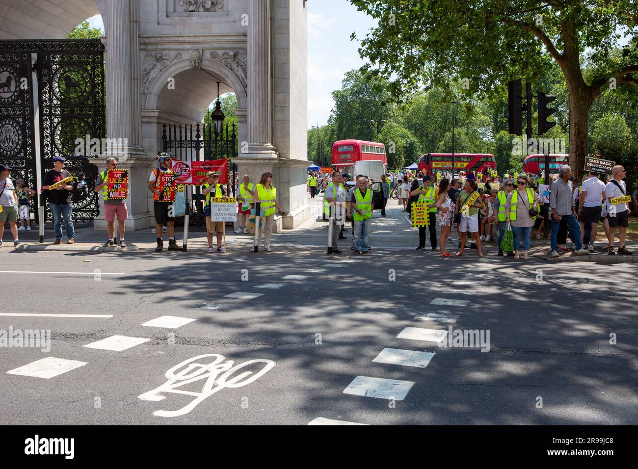 London, UK. 25th June, 2023. Activists hold placards expressing their ...