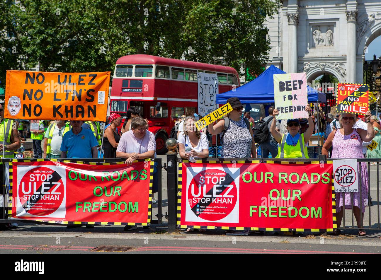 London, UK. 25th June, 2023. Activists hold banners and placards ...
