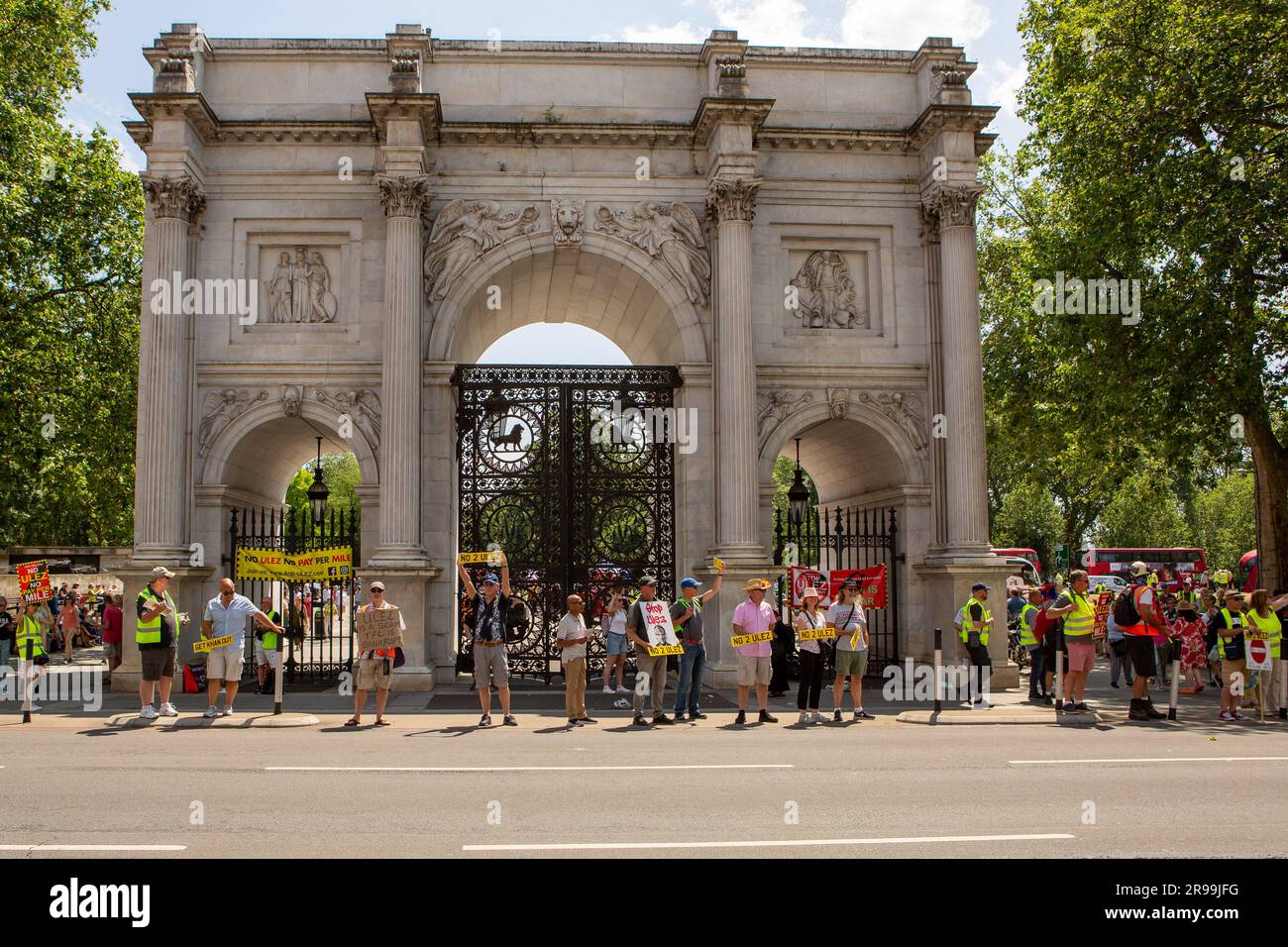 London, UK. 25th June, 2023. Activists hold placards expressing their ...