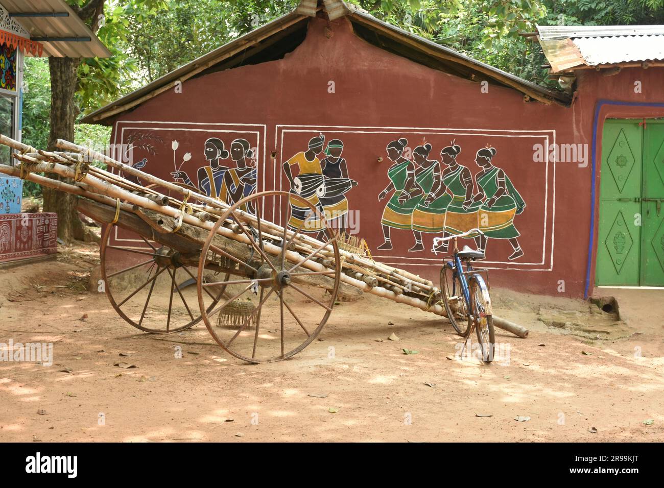 A bullock cart is parked in front of a beautiful rural house in Bolpur ...