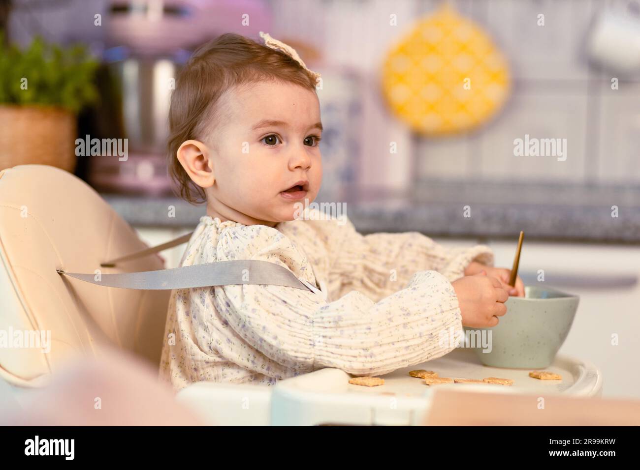Baby girl eating by herself hi-res stock photography and images - Alamy