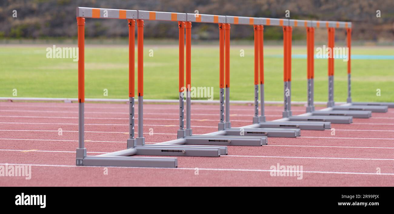 Eight track hurdles on a track in each lane Stock Photo - Alamy