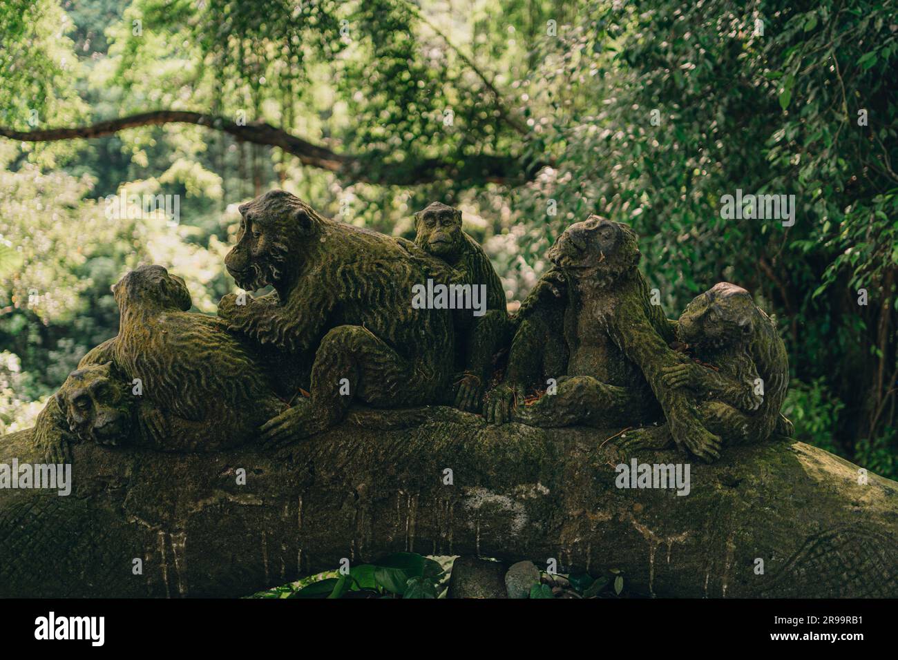 Stone monkeys statues in sacred monkey forest. Old decorative monkey sculptures in ubud sacred ...