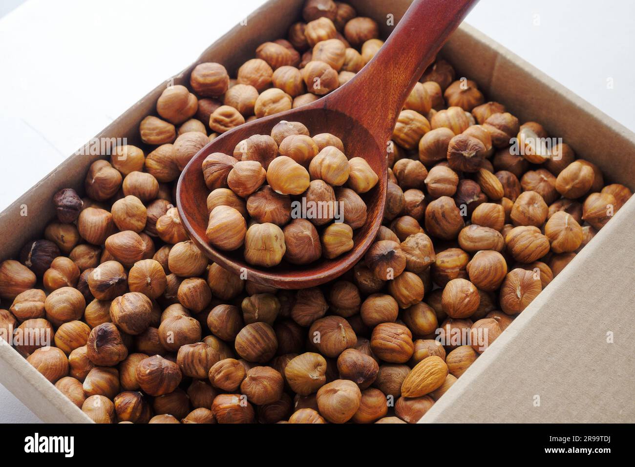 Box with peeled hazelnuts. View from above. Delivery of healthy nuts in ...