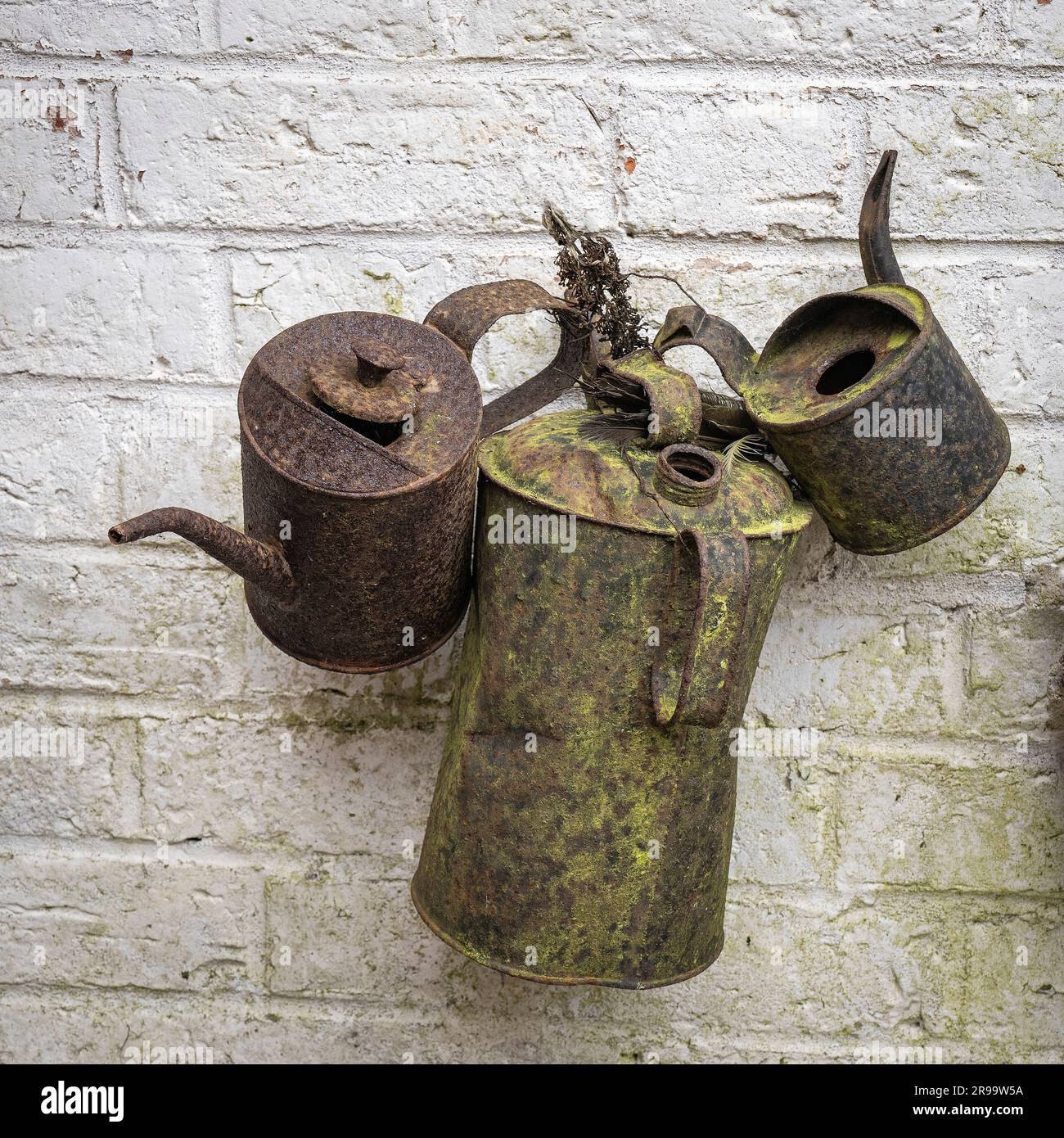 Three historical oilcans hanging on wall Stock Photo - Alamy