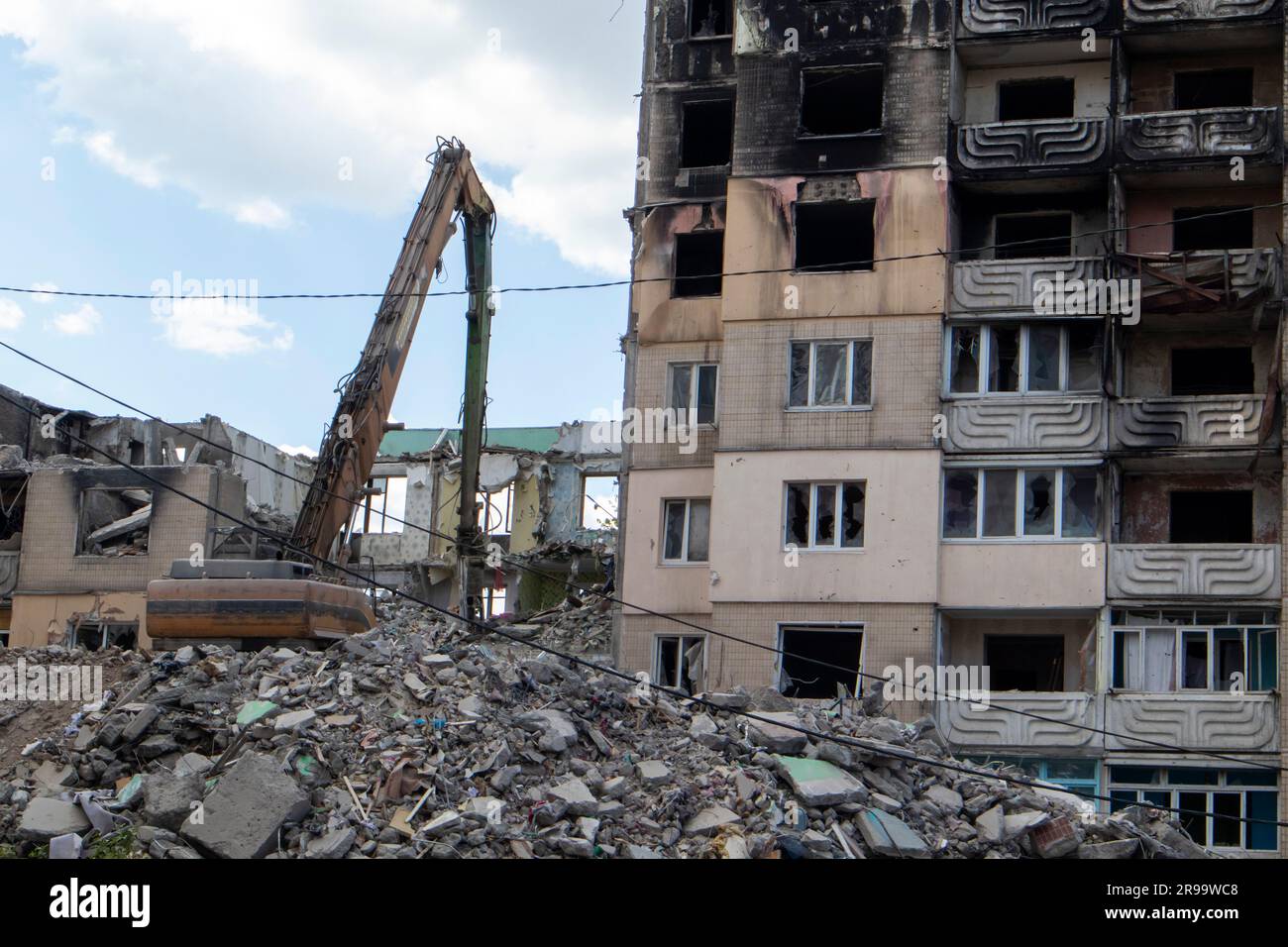 Excavator with hydraulic crusher at the demolition of a residential ...