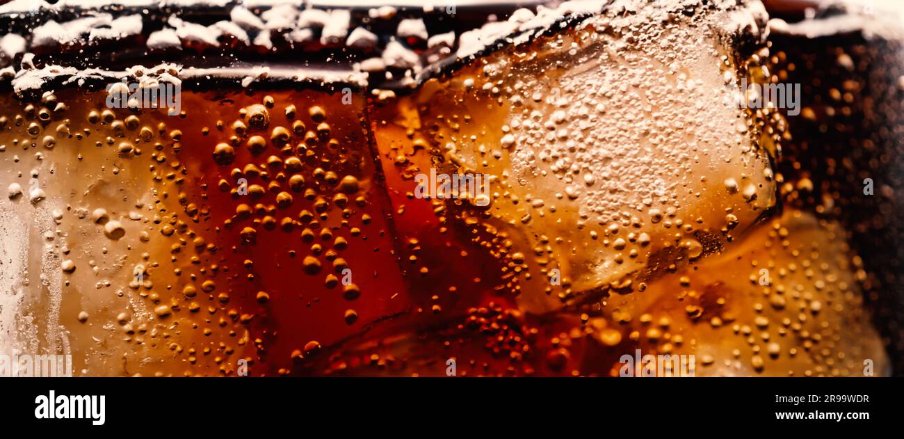 Cola with Ice. Close up of the ice cubes in cola water. Texture of ...