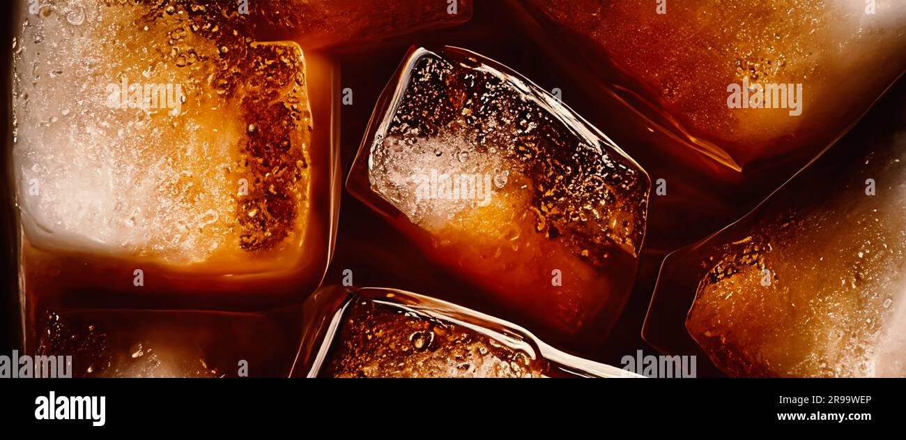 Cola with Ice. Close up of the ice cubes in cola water. Texture of carbonate drink with bubbles ...