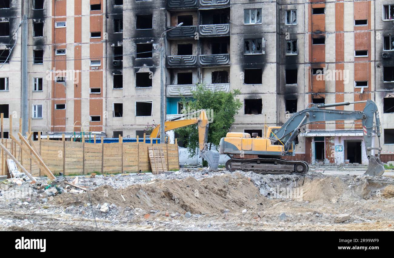 Excavator with hydraulic crusher at the demolition of a residential ...