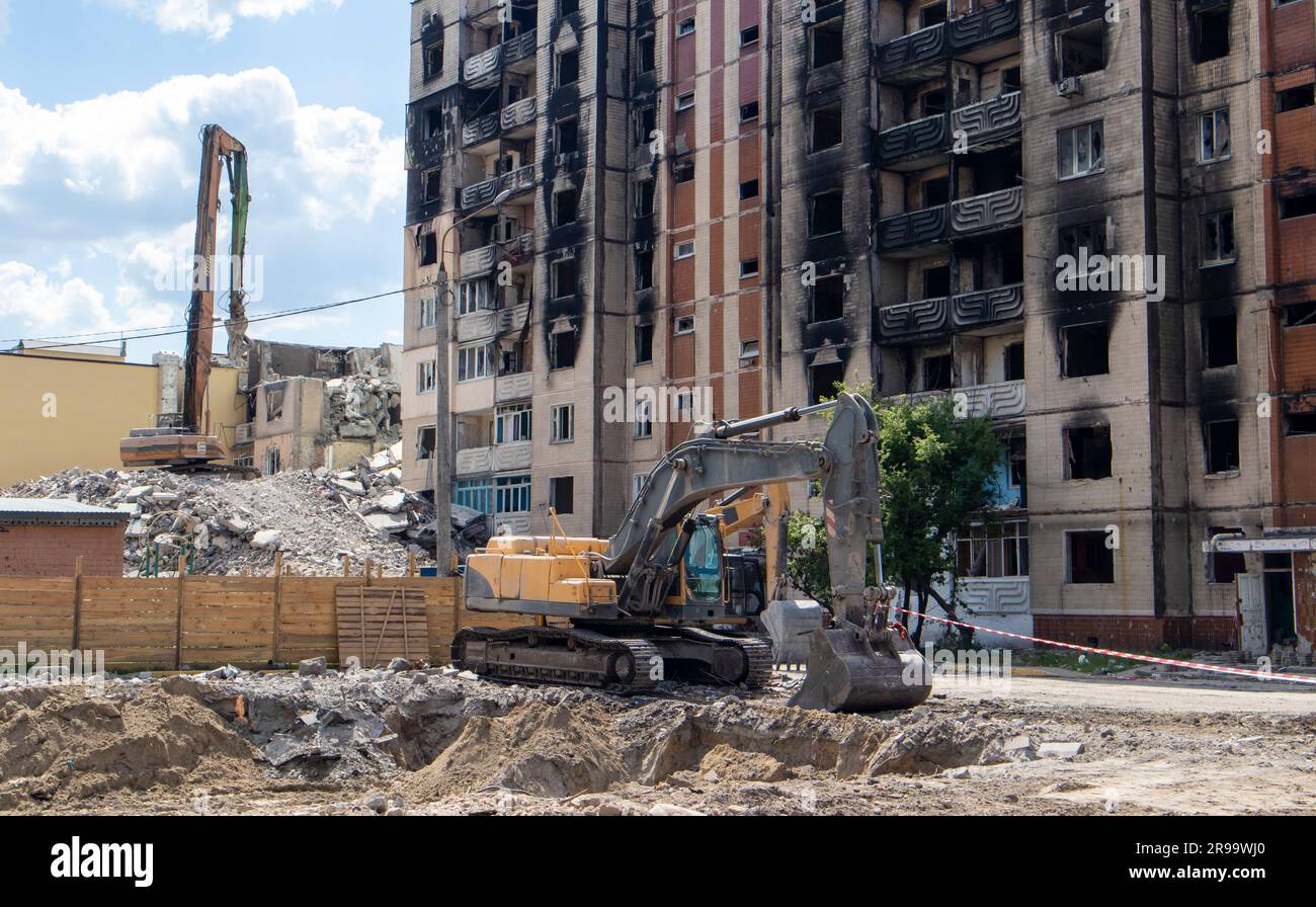 Excavator with hydraulic crusher at the demolition of a residential ...