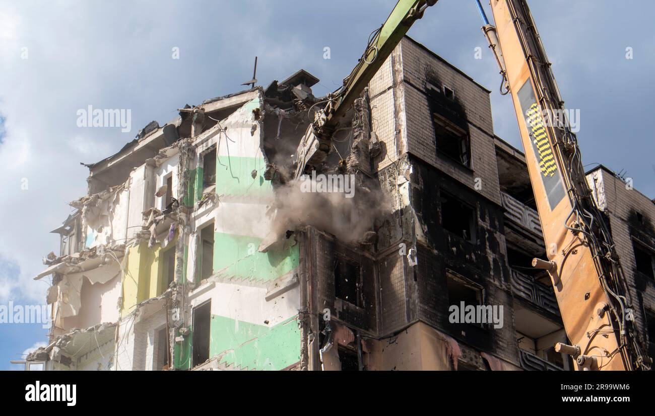 Excavator with hydraulic crusher at the demolition of a residential ...