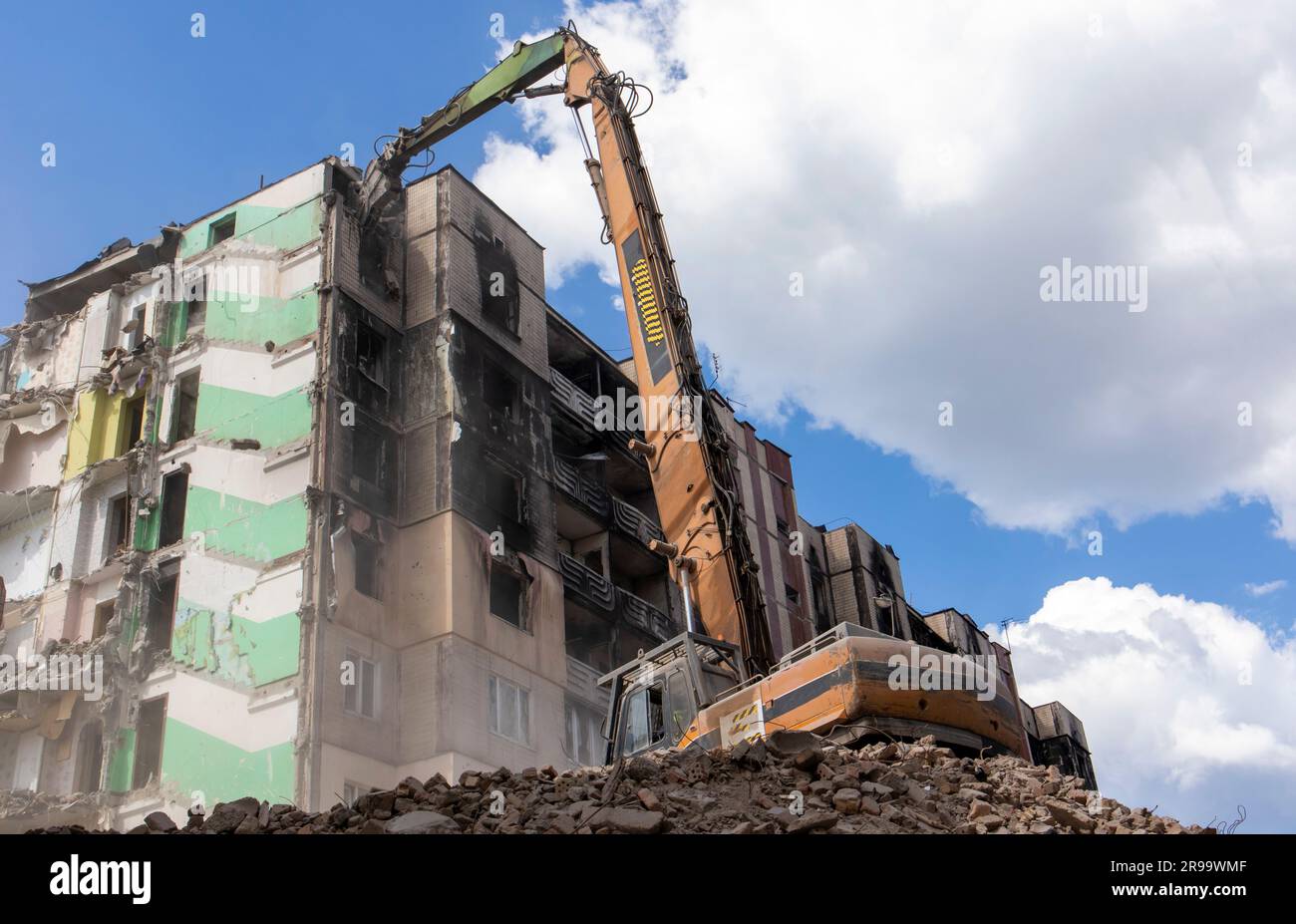 Excavator with hydraulic crusher at the demolition of a residential ...