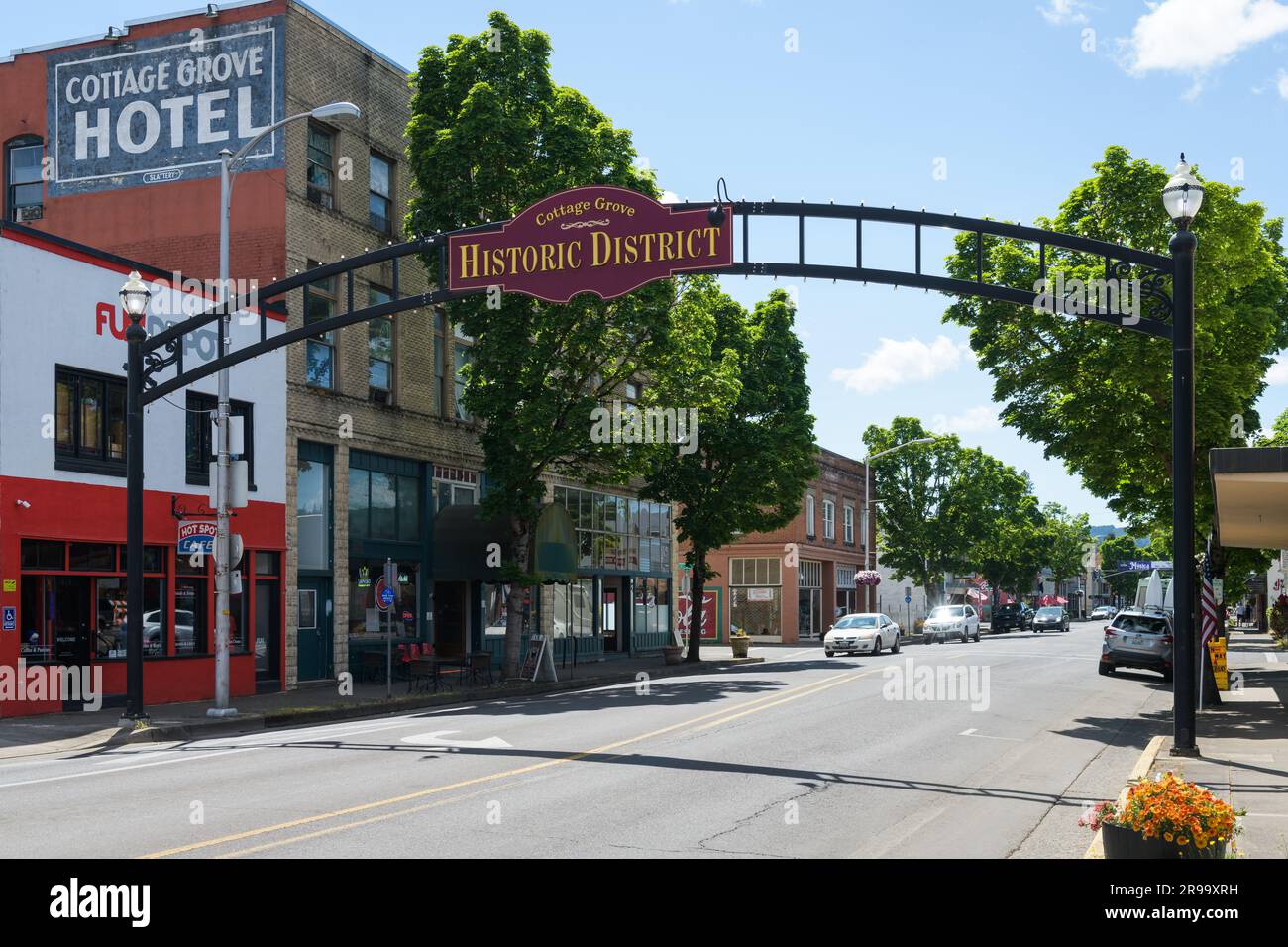 Cottage Grove, OR, USA - June 13, 2023; Arched sign across East Main ...
