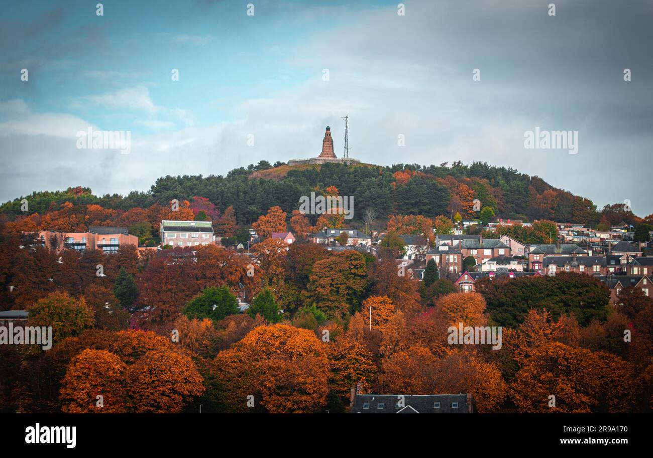 An aerial view of a picturesque cityscape nestled at the base of a lush ...