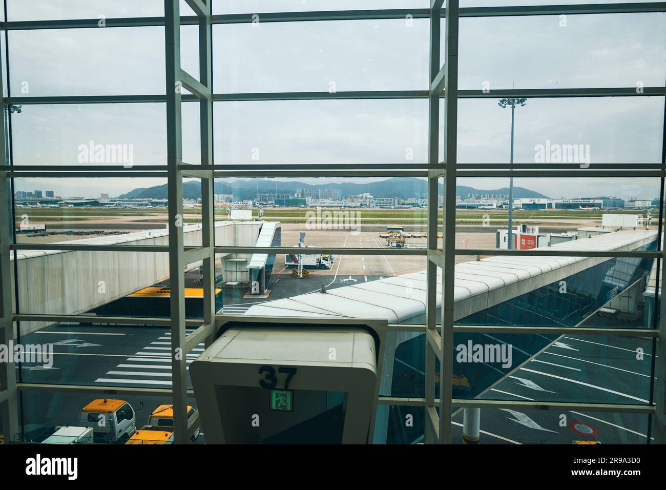 A view of an airport terminal is seen through a glass window Stock ...