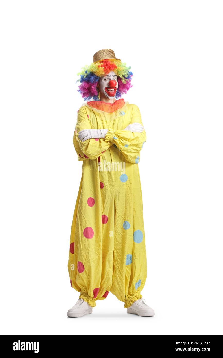Full length portrait of a clown in yellow clothes posing with crossed ...