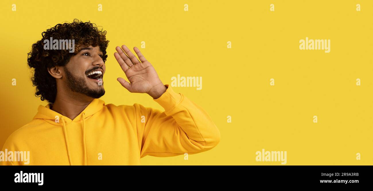 Excited young indian guy screaming towards copy space Stock Photo - Alamy