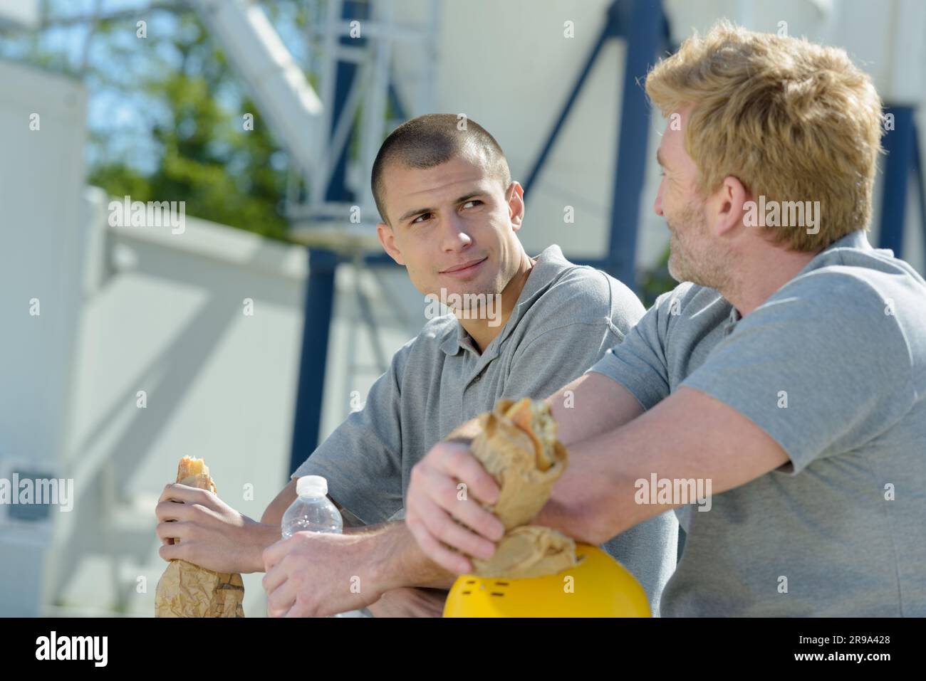 two male construction workers eating sandwiches for lunch Stock Photo ...