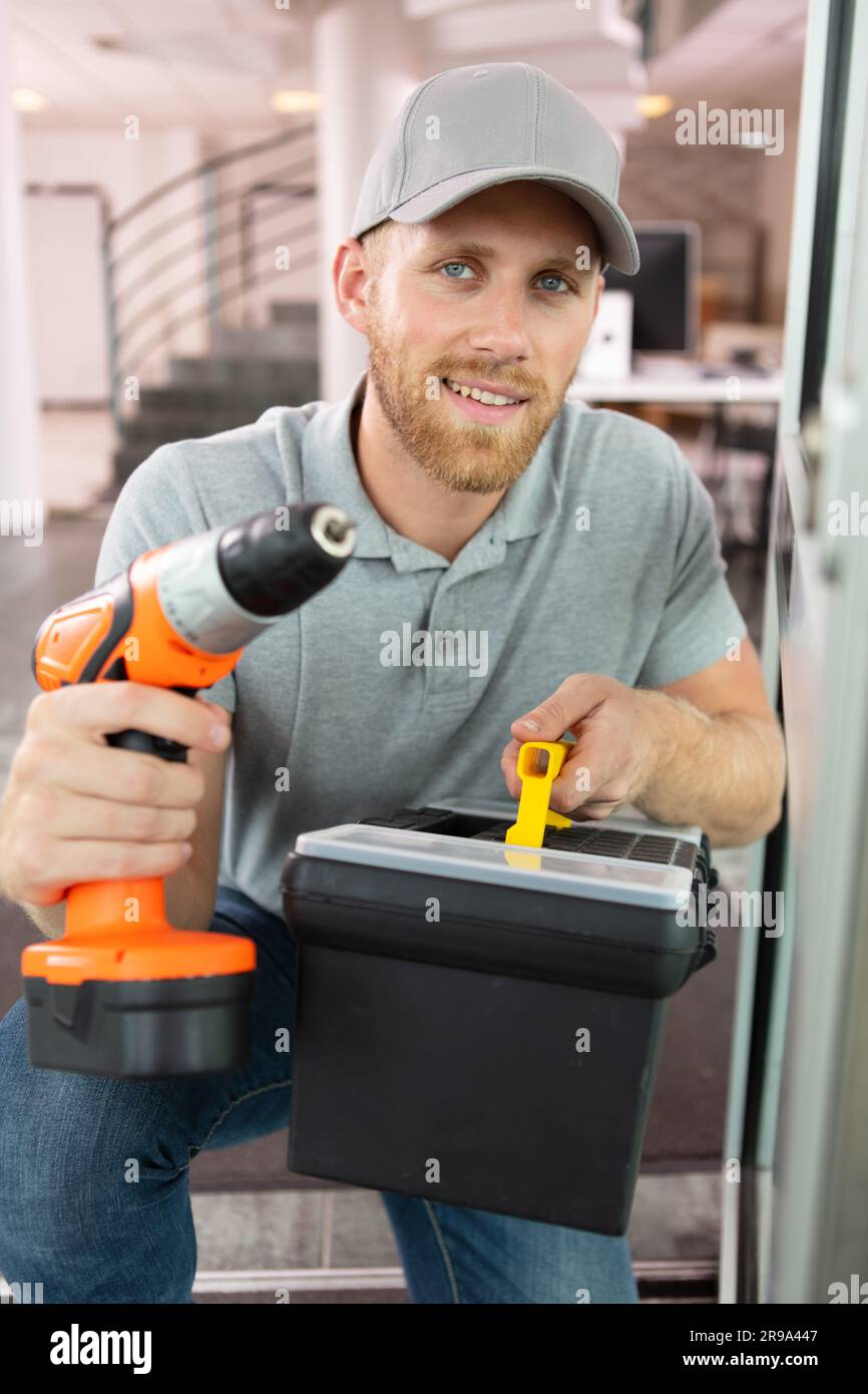 handyman with toolbox and cordless power-tool Stock Photo - Alamy