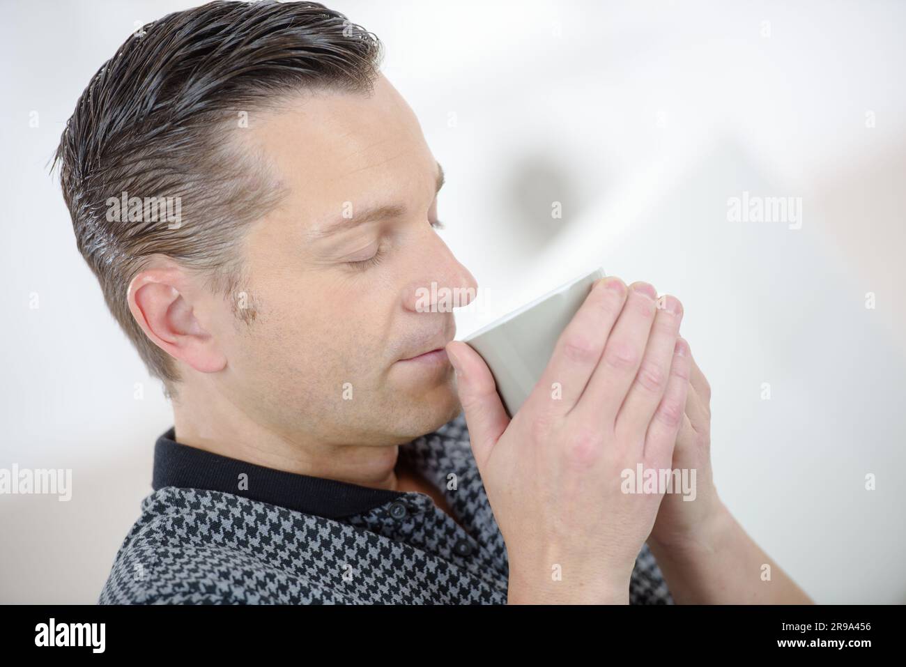 Young latin man smelling cup hi-res stock photography and images - Alamy