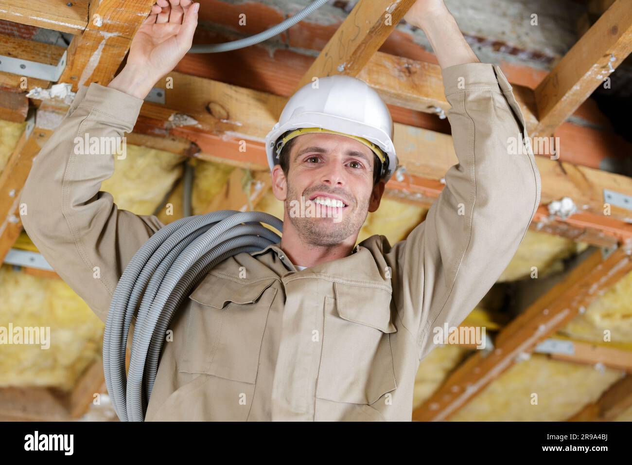 man marking position of cable trunking Stock Photo - Alamy