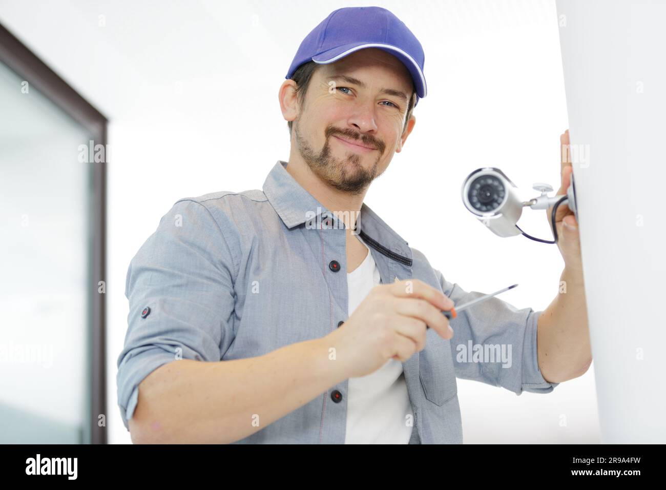contractor installing surveillance cctv cameras in office Stock Photo ...