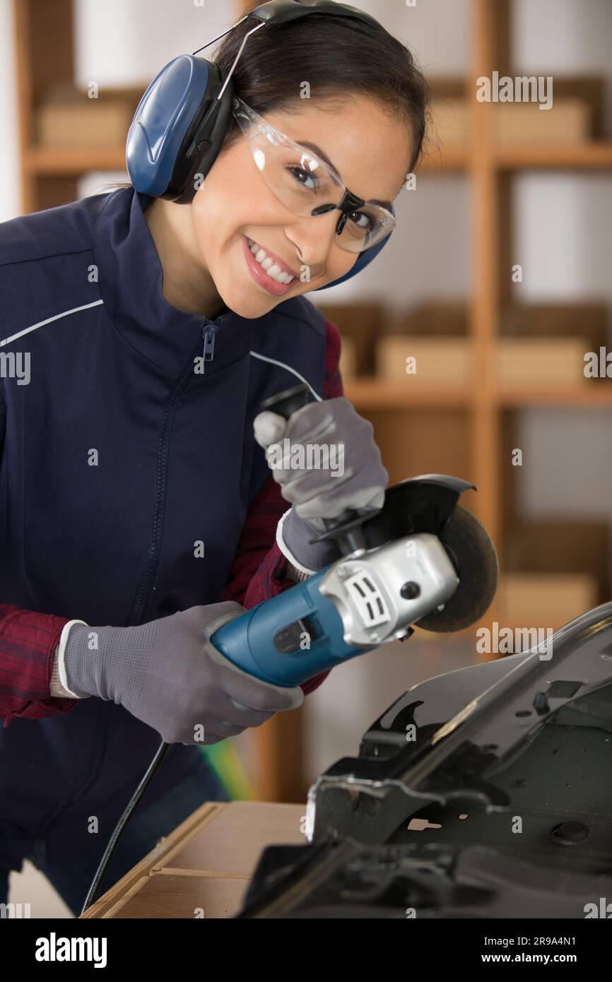 female worker using angle grinder Stock Photo - Alamy