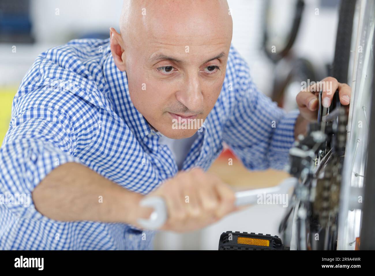 Mature man repairing bicycle hi-res stock photography and images - Alamy