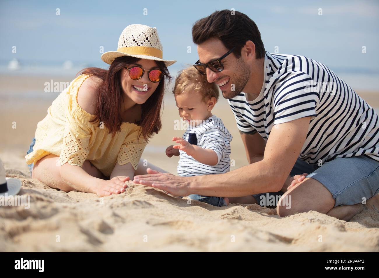 mother father and baby feet at the sea f Stock Photo - Alamy