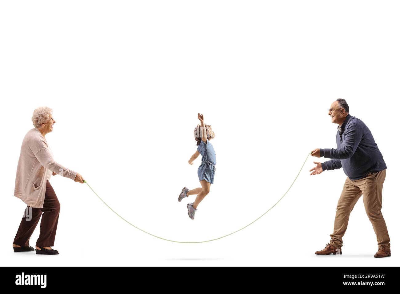 Grandparents playing skipping rope with granddaughter isolated on white ...