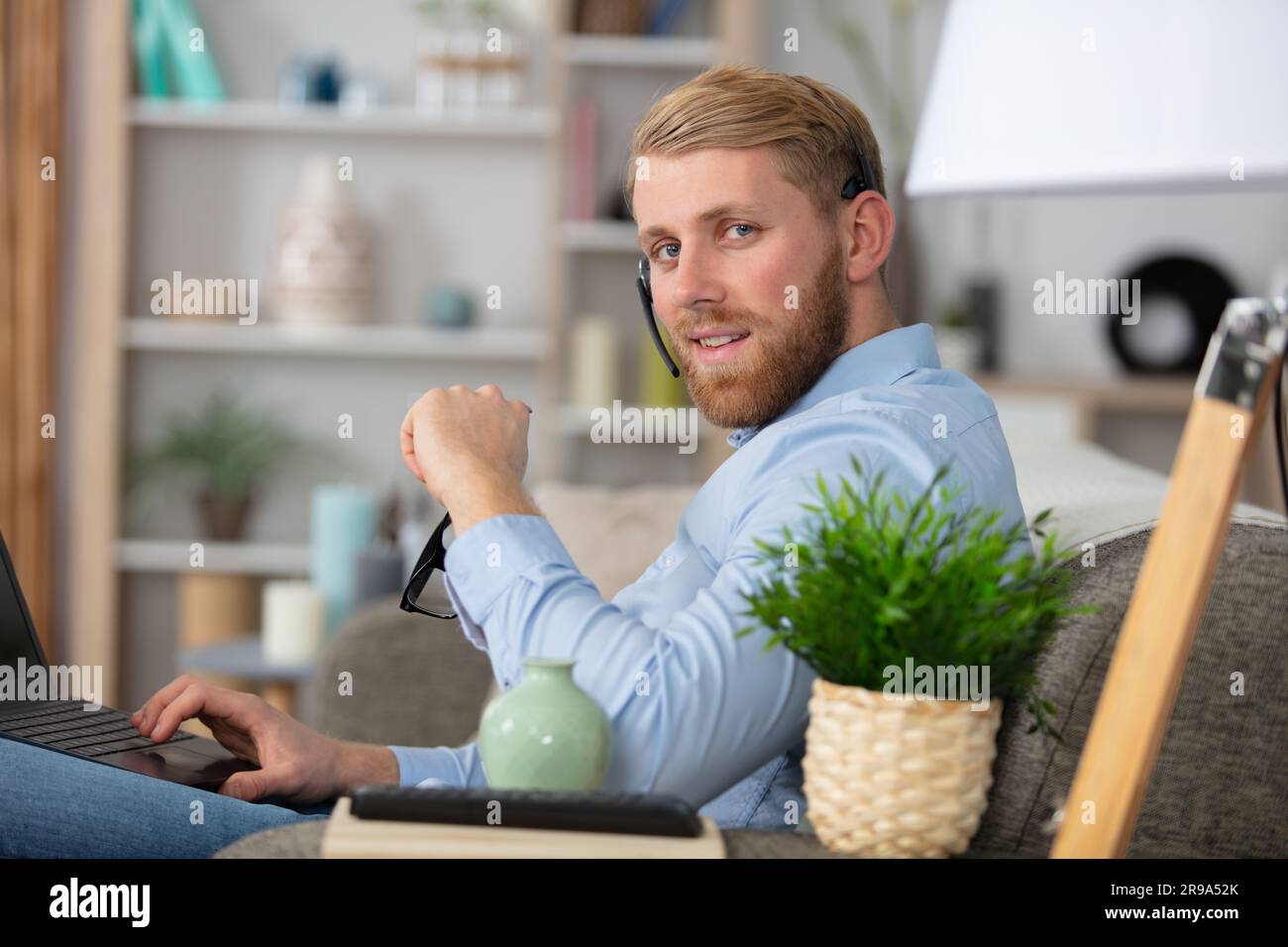 Young man holding remote control hi-res stock photography and images ...