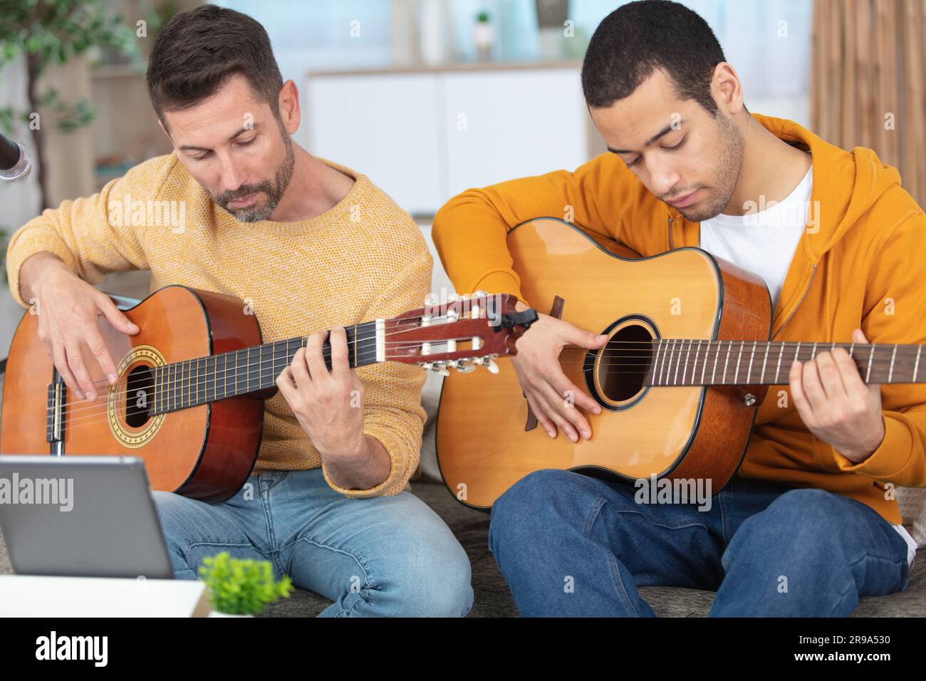 Two men playing guitars on hi-res stock photography and images - Alamy