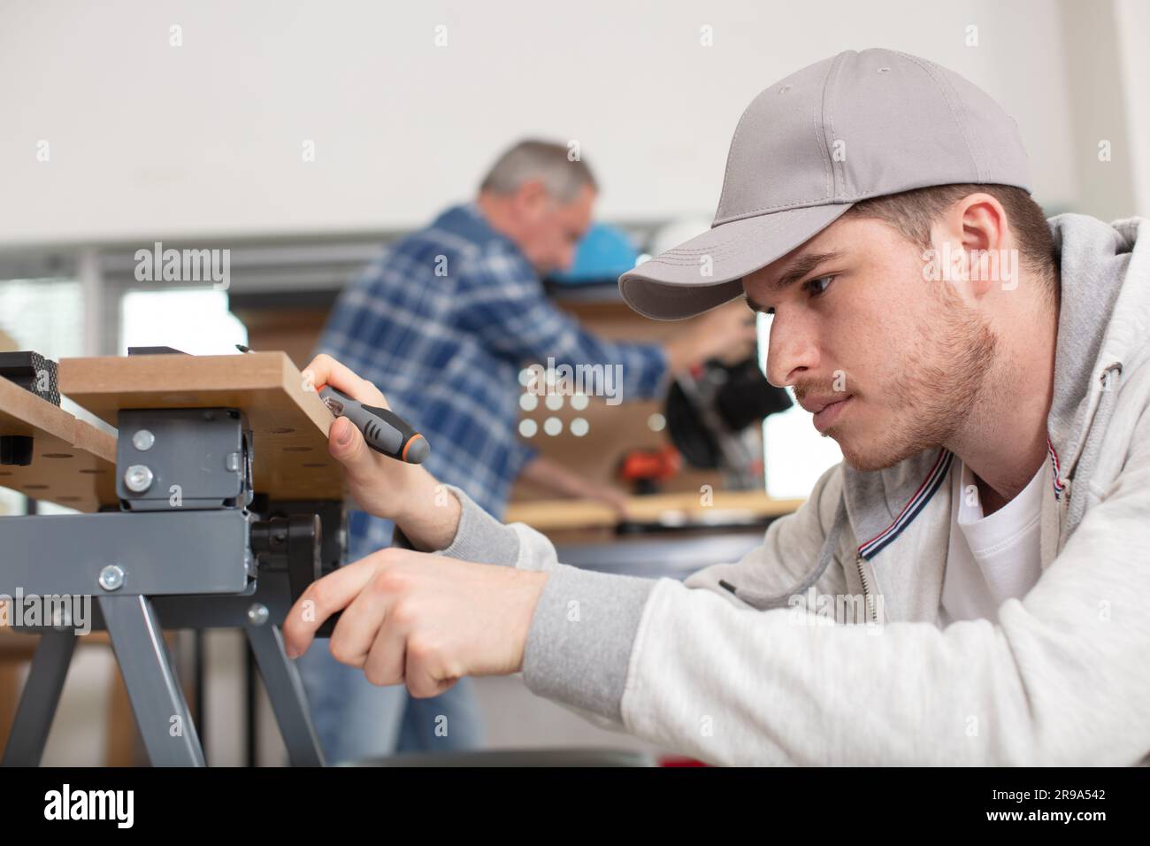 Male apprentice working carpenter in hi-res stock photography and ...