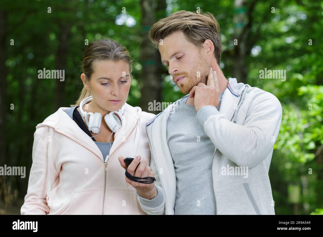 sportsman checking the pulse in his neck Stock Photo - Alamy