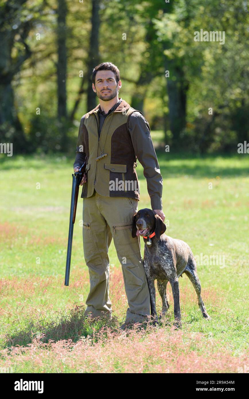 hunter and his dog waiting Stock Photo - Alamy